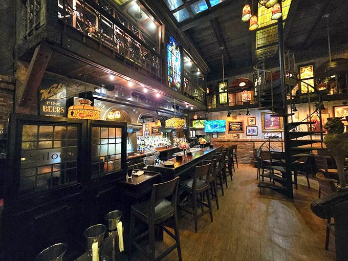 The bar area feels like a cathedral dedicated to the worship of fine spirits, with stained glass windows filtering light onto polished wood and gleaming bottles.
