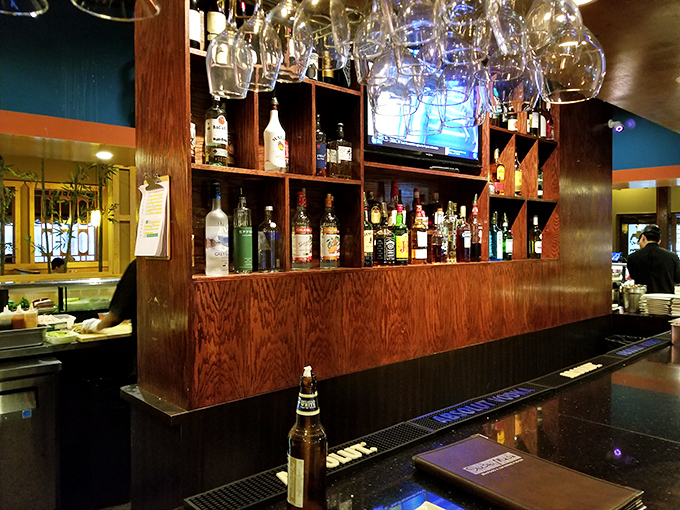 The bar setup isn't just serving drinks; it's serving possibilities. Each bottle is a different story waiting to complement your sushi saga.