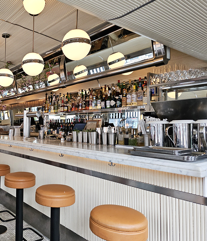 The bar gleams with promise under globe pendant lights, with leather stools that invite you to perch and ponder life's important questions, like "Another cocktail?"