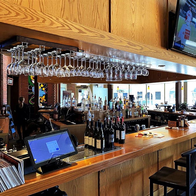 The well-stocked bar stands ready to craft liquid accompaniments worthy of the culinary masterpieces emerging from the kitchen.