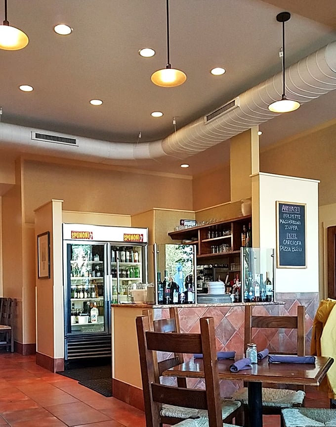 Where libations meet tradition &ndash; the bar area's warm glow and well-stocked shelves promise the perfect Chianti to complement your Neapolitan feast.