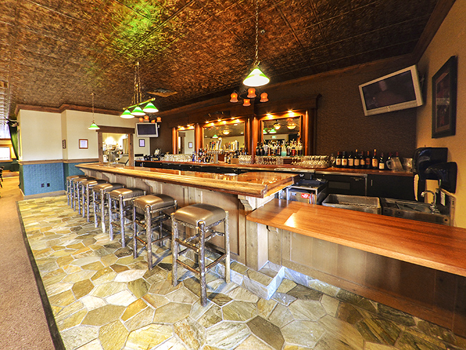 The bar area doesn't just serve drinks&mdash;it serves community. A place where strangers become friends over bourbon and brisket tales.