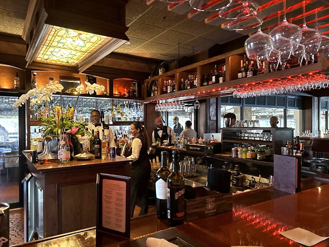 The welcoming bar area beckons with polished wood, gleaming glassware, and bartenders who know their craft well.