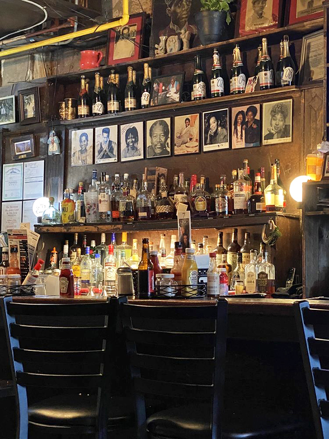 The bar area doesn't just serve drinks; it serves history &ndash; bottles standing at attention while photographs of neighborhood legends keep watch.