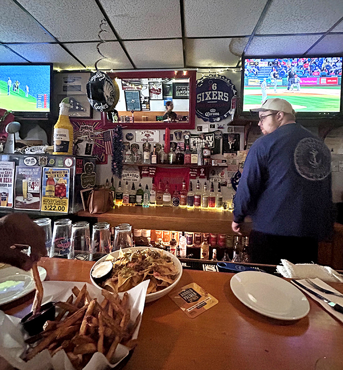 The bar area is a shrine to Philadelphia sports, where strangers become friends and friends become family over shared victories and heartbreaks.