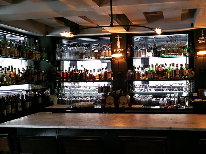 The bar doesn't just serve drinks&mdash;it showcases them like the liquid art forms they are, backlit for dramatic effect worthy of Broadway.