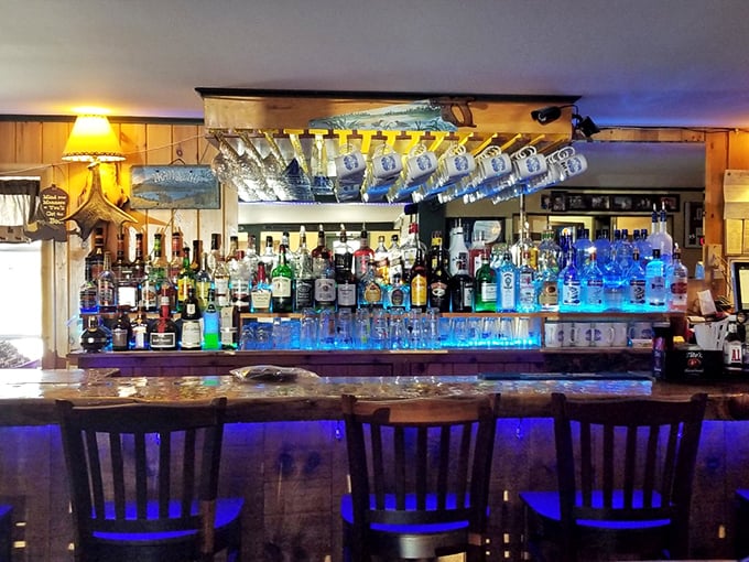 The bar glows with blue light and amber spirits, promising the kind of evening where "just one drink" turns into memorable stories.