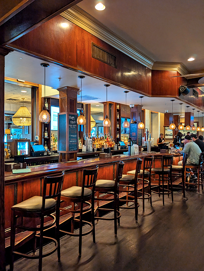 The bar area glows with warm wood and amber lighting, creating that magical space where "I'll just have one drink" becomes "What time is it?"