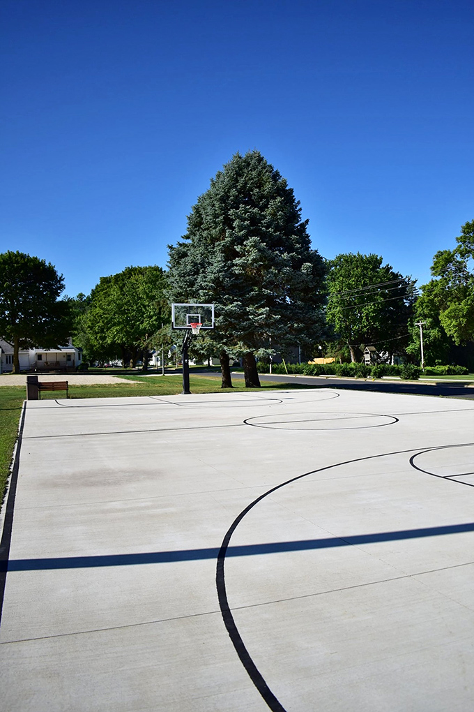 Basketball courts in small towns aren't just recreational spaces—they're community centers where generations gather, compete, and connect under towering trees.