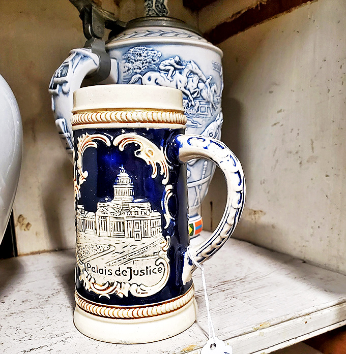 This ornate beer stein doesn't just hold your beverage—it tells a story. "Palais de Justice" suggests it traveled farther to Maine than you did.