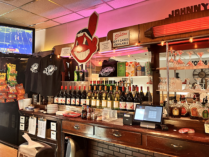 The bar area balances nostalgia with necessity, where Cleveland sports memorabilia watches over glasses of cold beer and wine.