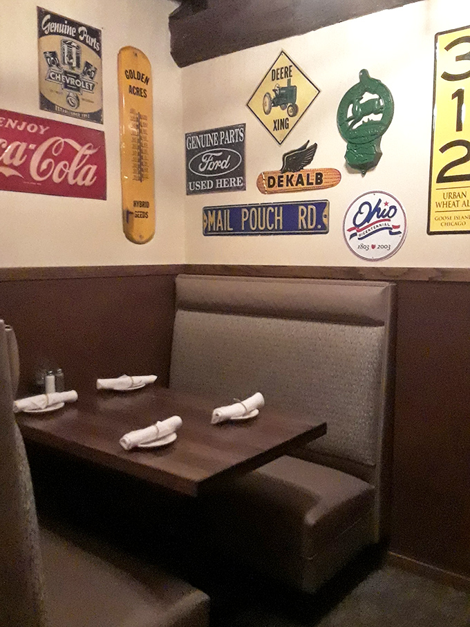 Vintage signs adorn walls where farm implements once hung. John Deere crossing signs: the Midwest version of designer wallpaper.