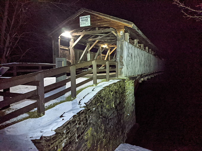 Night transforms the bridge into something magical&mdash;illuminated timber glowing against the darkness like a lantern from the past.
