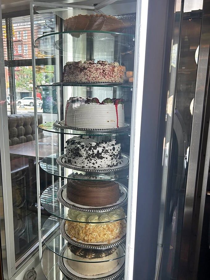 The rotating cake display&mdash;New York's most tempting real estate where every shelf offers a different path to dessert nirvana.