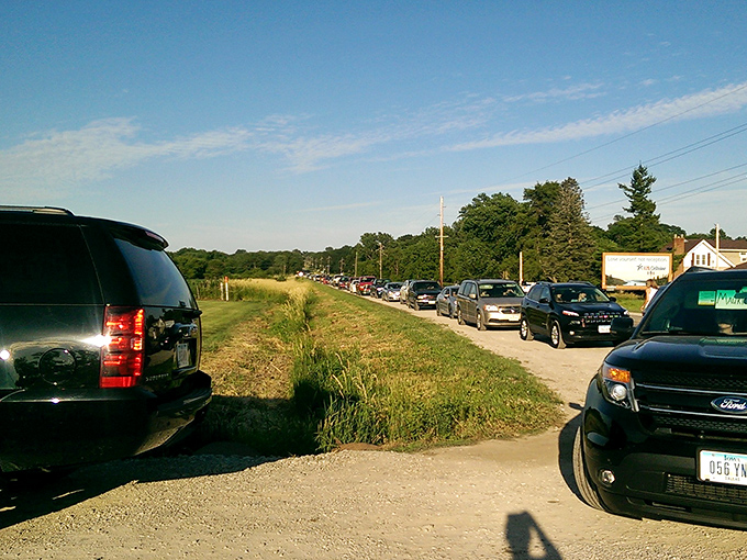 The line of cars stretches down the road, a testament to the enduring appeal of watching movies beneath the stars.