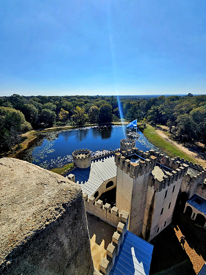 Spectacular aerial perspective captures the castle's impressive scale and its picturesque lakeside setting in rural Texas.