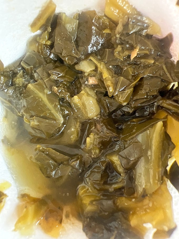 Collard greens swimming in pot likker so good you'll be tempted to ask for a straw &ndash; Southern comfort in vegetable form.