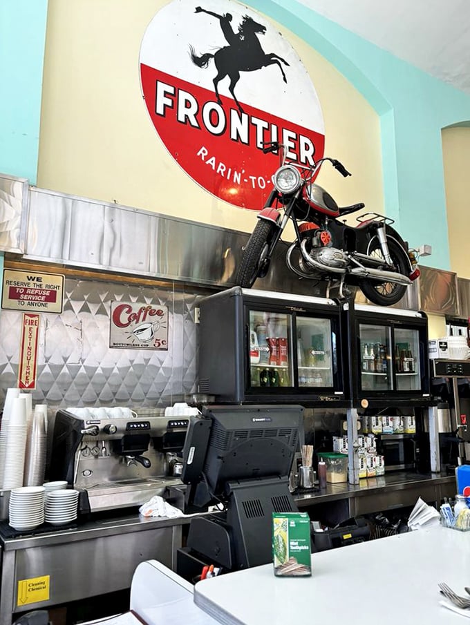 At the counter, a vintage motorcycle perched above refrigerators proves that in San Francisco, even diners have a flair for the dramatic.
