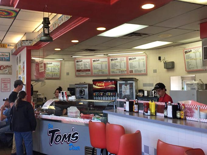 The counter where magic happens – red stools invite you to sit and watch short-order wizardry in action.