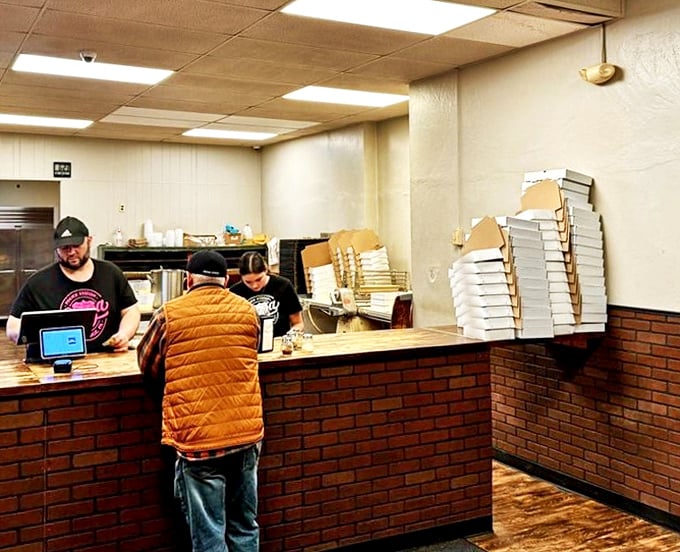 The brick counter has witnessed decades of pizza transactions&mdash;a simple barrier between hungry customers and the culinary magic happening behind it.