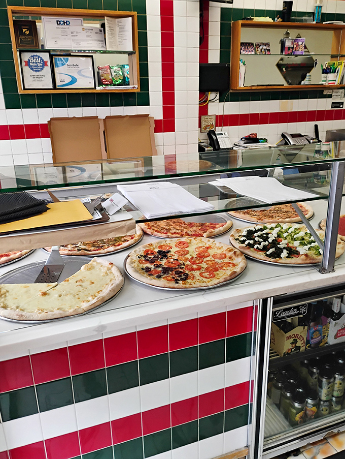 Pizza display cases: the adult version of a toy store window. Each pie patiently waits its turn to make someone's day exponentially better.