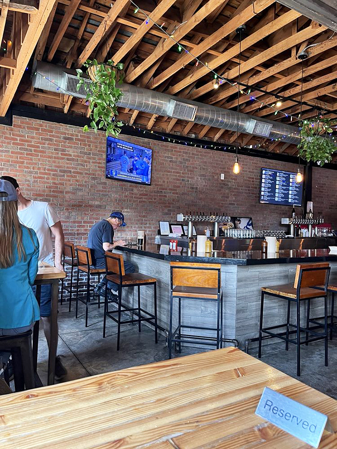 The bar area where barbecue dreams and craft beer aspirations come together under twinkling lights and exposed beams.