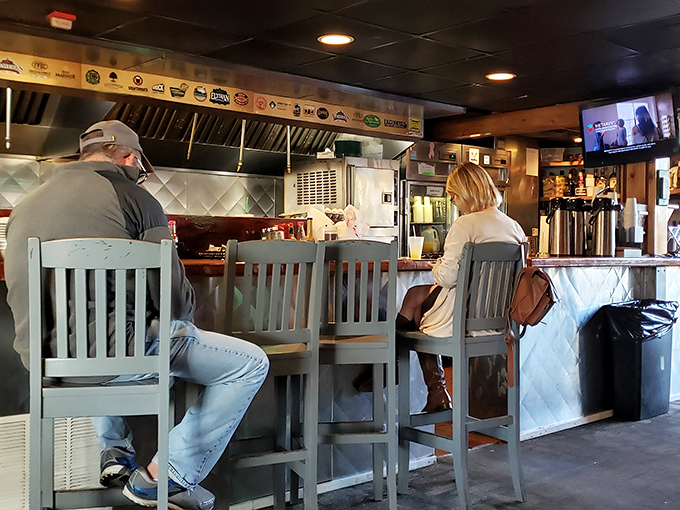 Where culinary magic happens. The counter seating offers a front-row view to the kitchen choreography that transforms fresh catches into memorable meals. 