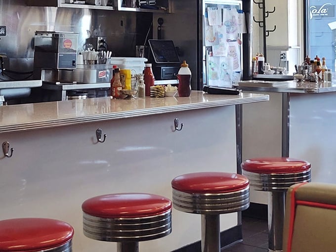 The counter view &ndash; where regulars perch on those iconic red stools, watching their breakfast materialize before their eyes in a symphony of sizzles.