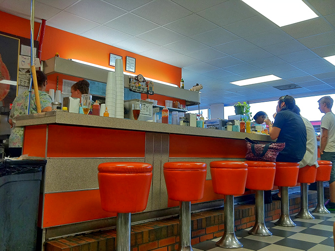 Those flame-orange counter stools have supported generations of Norfolk residents, from first dates to family traditions, all united by the pursuit of the perfect shake.