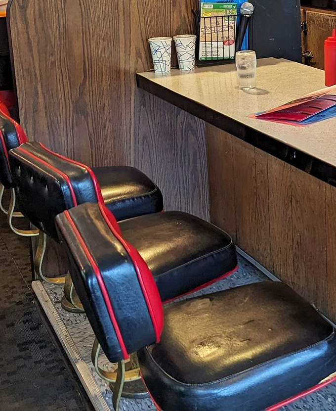 Counter seating where solo diners become philosophers and regulars become family over coffee refills.