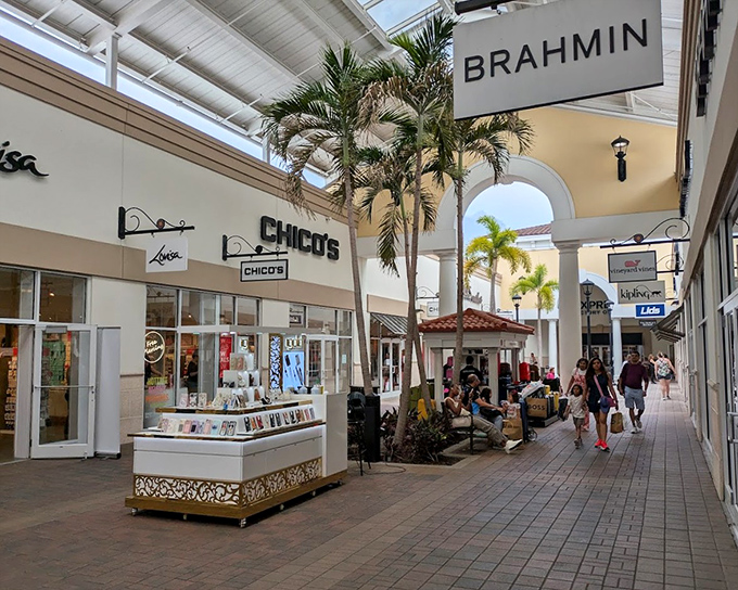 Indoor-outdoor walkways lined with palm trees create the illusion you're strolling through a resort, not embarking on a shopping marathon.