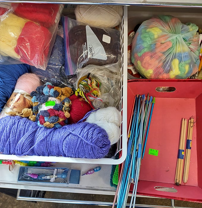 A crafter's paradise of colorful yarns and needles &ndash; someone's abandoned project becomes another's creative inspiration.