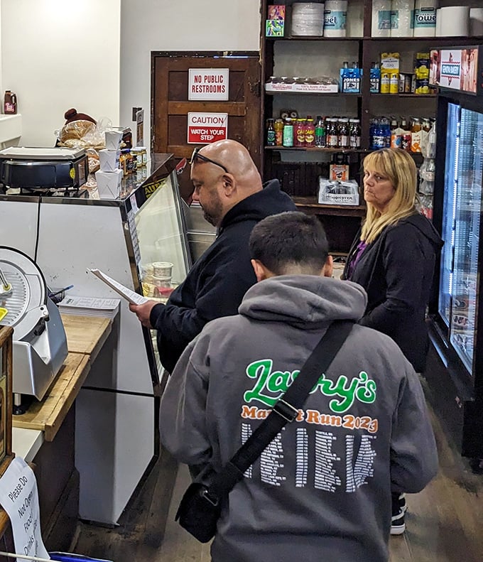 The sacred transaction: customers patiently waiting for their turn at sandwich nirvana. Some pilgrimages involve standing in line.