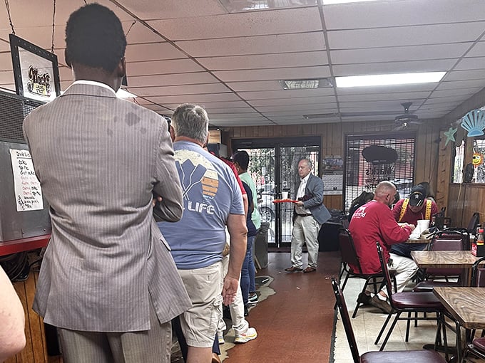 The lunch line at Mack's is democracy in action—suits and work boots standing shoulder to shoulder in pursuit of burger perfection.