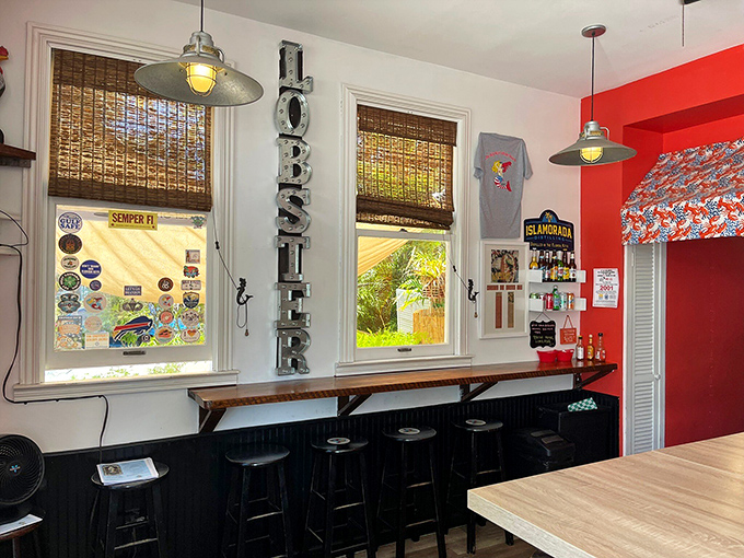 The vertical "LOBSTER" sign serves as both decoration and emergency beacon for the seafood-deprived. Those bamboo blinds filter in just the right amount of Key West sunshine.