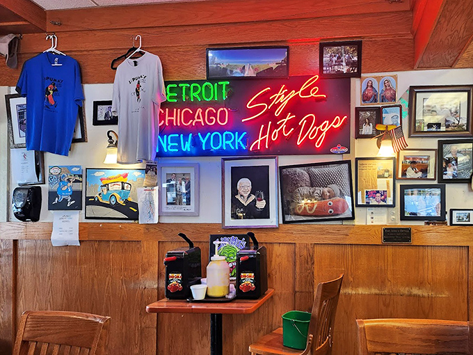 The neon proclamation of hot dog allegiances lights up the wall like a declaration of delicious independence. Detroit, Chicago, and New York united at last!