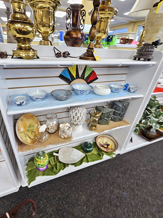 Decorative treasures arranged like a museum of suburban elegance. Those brass urns definitely graced a 1980s country club mantel.