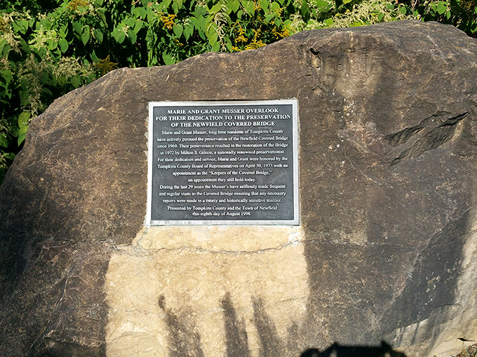 This dedication plaque honors the bridge's champions who ensured this wooden wonder would be preserved for future generations to discover and enjoy.