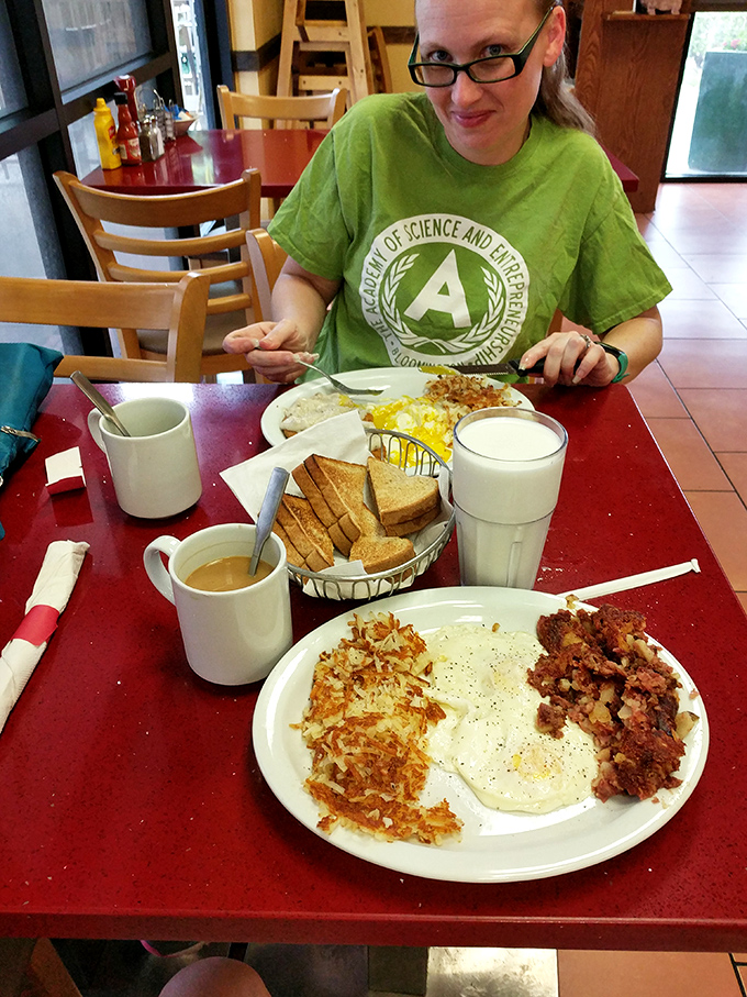A happy diner enjoying the simple pleasure of eggs, hash browns, and toast&mdash;the breakfast trinity that never disappoints.