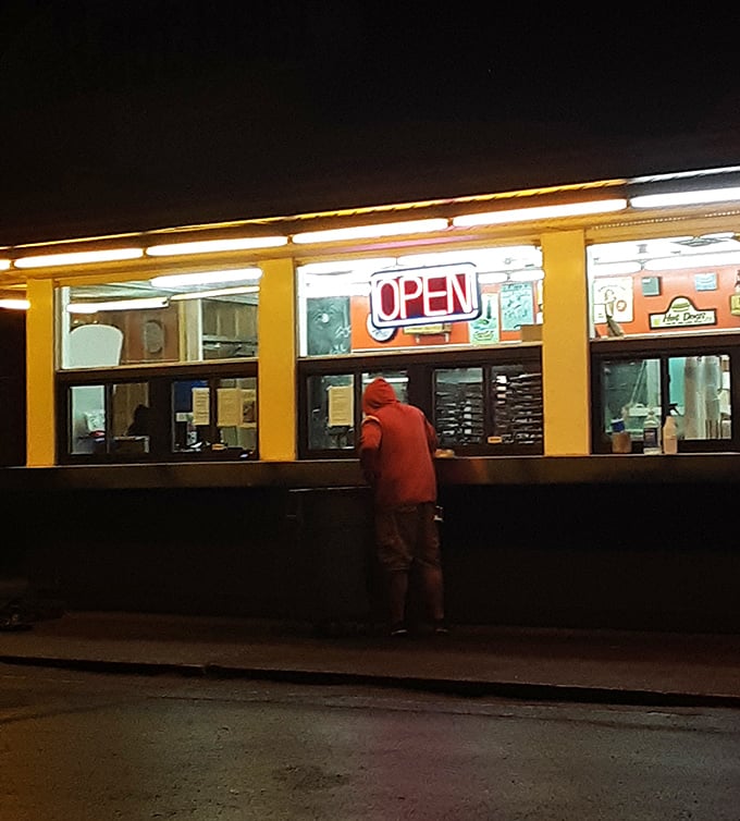 Night falls, but hunger doesn't. The warm glow of "OPEN" beckons like a lighthouse for those seeking comfort food after dark.