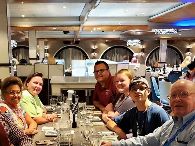 Diners gathered around a table, proving that good food has always been the original social network, connecting people long before the internet.