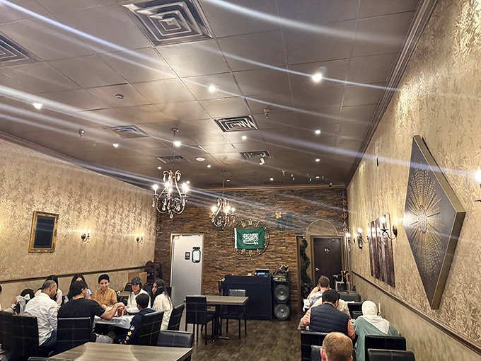 Chandeliers cast a warm glow over textured walls &ndash; creating an ambiance that makes even waiting for your food a pleasure.