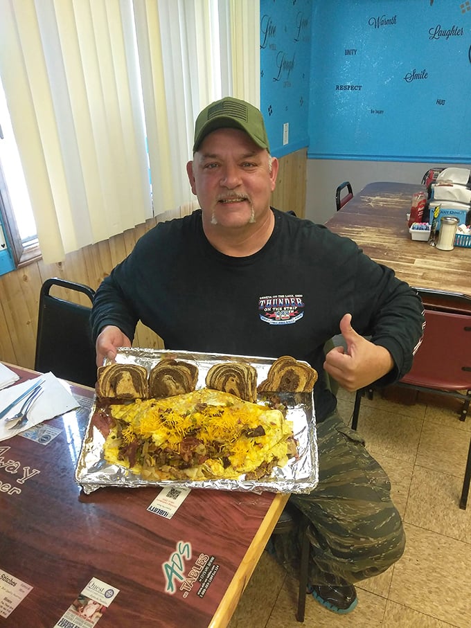 This happy diner gives the thumbs-up to what appears to be the breakfast equivalent of hitting the lottery. That's a meal worth smiling about!