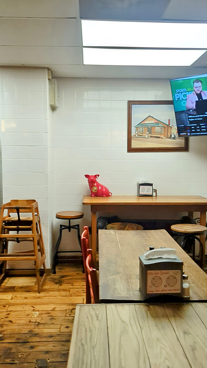 Simple wooden tables, a red pig figurine standing guard, and a TV for company&mdash;because good barbecue deserves comfortable surroundings.