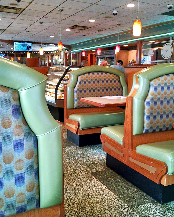 The dining area's mint green booths with retro polka dot upholstery tell you this place values comfort over trends. Exactly as it should be.