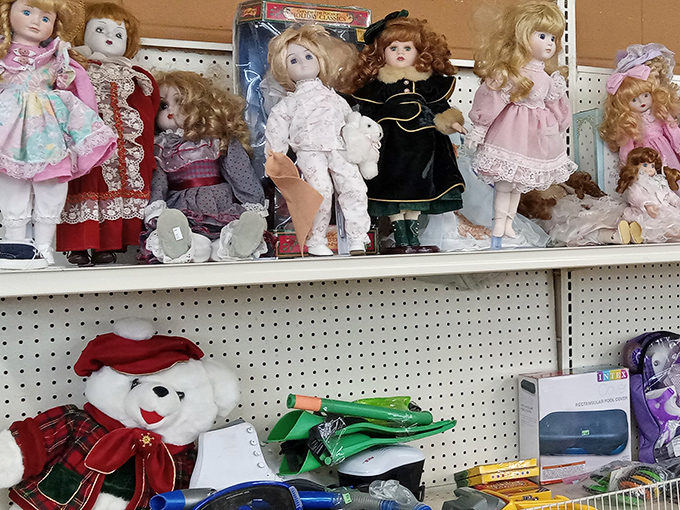 The doll collection's glass eyes follow you&mdash;a porcelain audience in petticoats and ribbons judging your thrifting choices.