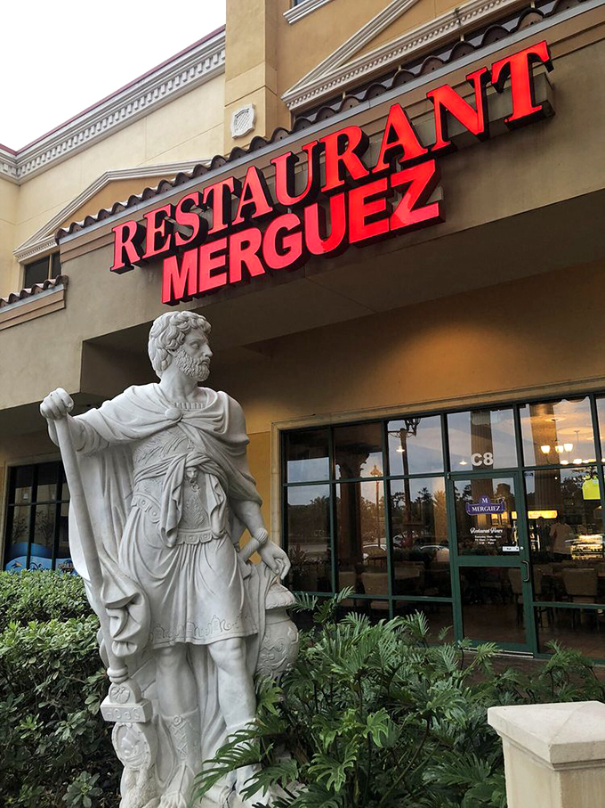 The statue stands guard outside like he's thinking, "You have no idea what deliciousness awaits you inside these doors."