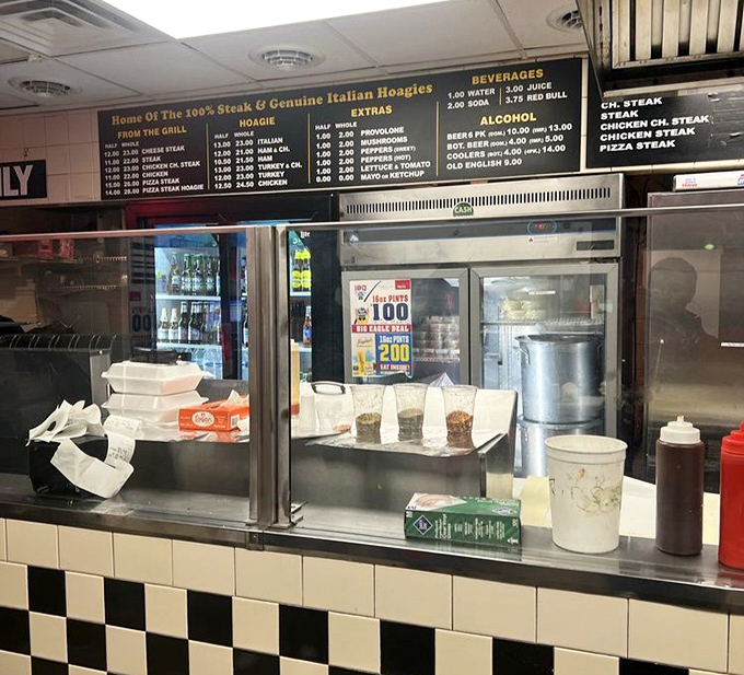 Behind the counter, where the magic happens. Those condiment bottles stand ready for the finishing touches on sandwich perfection.