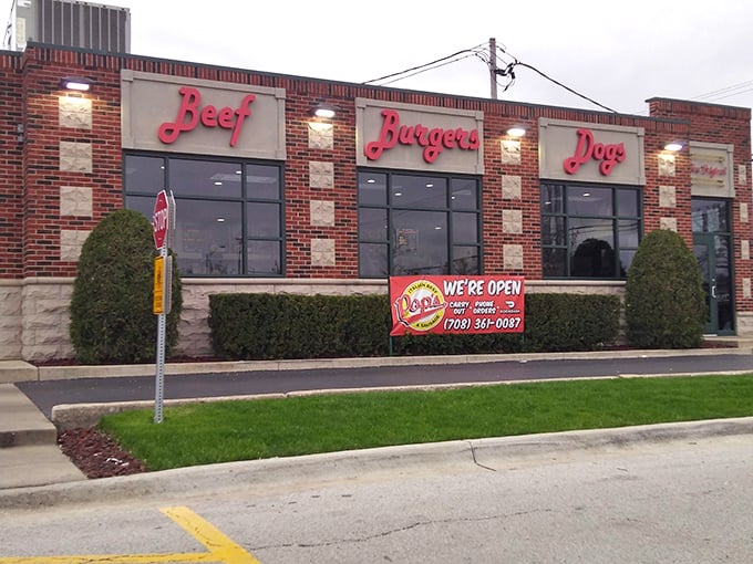 The storefront at dusk, when the red "Beef, Burgers, Dogs" signs glow like beacons of hope for the hungry commuter.