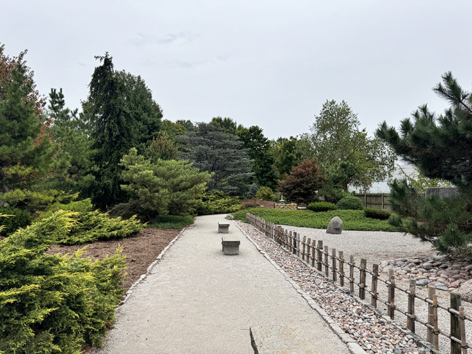 Minimalism at its finest: a perfectly raked gravel path invites contemplation with strategically placed benches. Sometimes less truly is more.